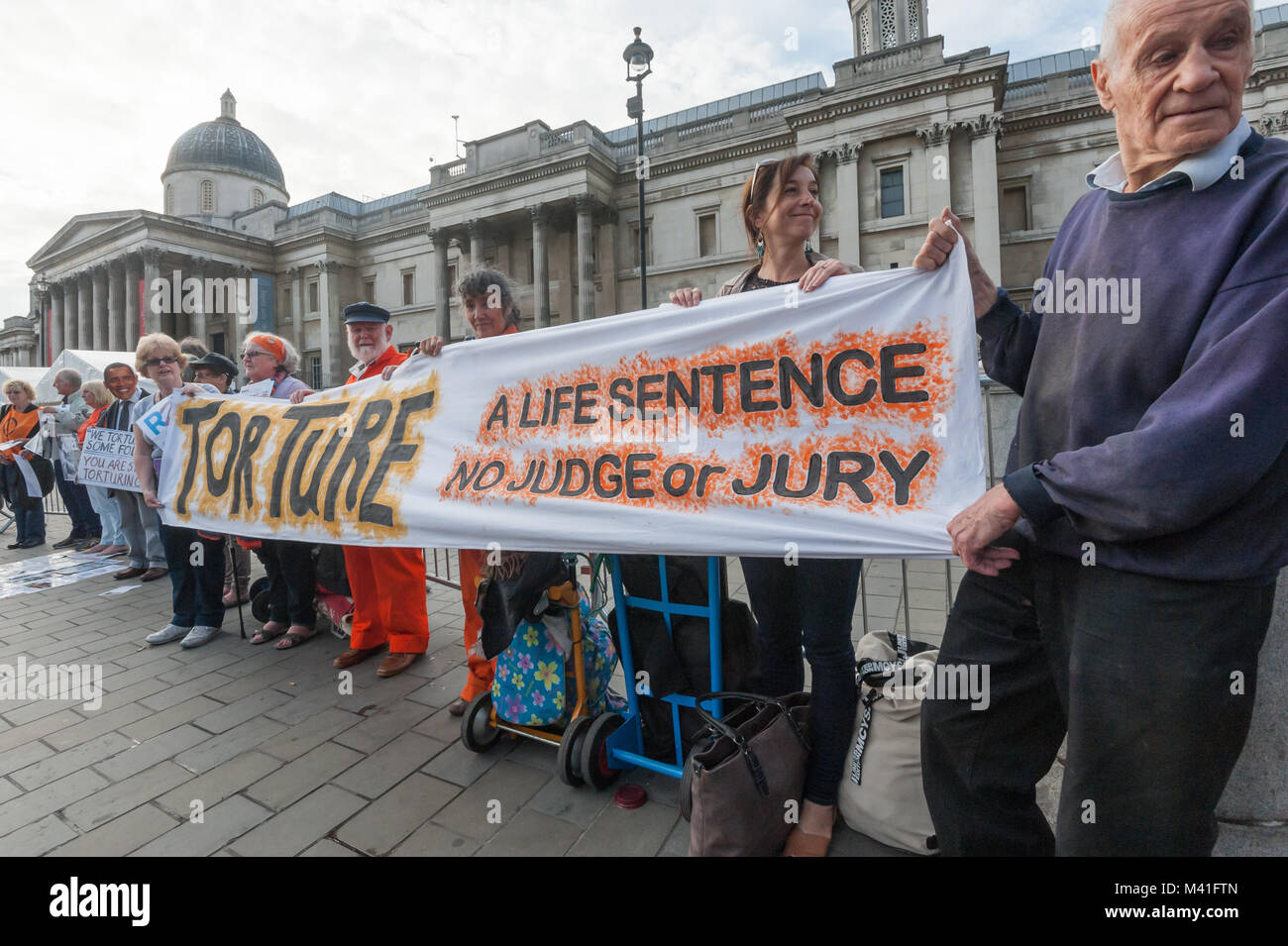 People hold a banner 'Torture - a ilfe sentence No Judge or Jury' at ...
