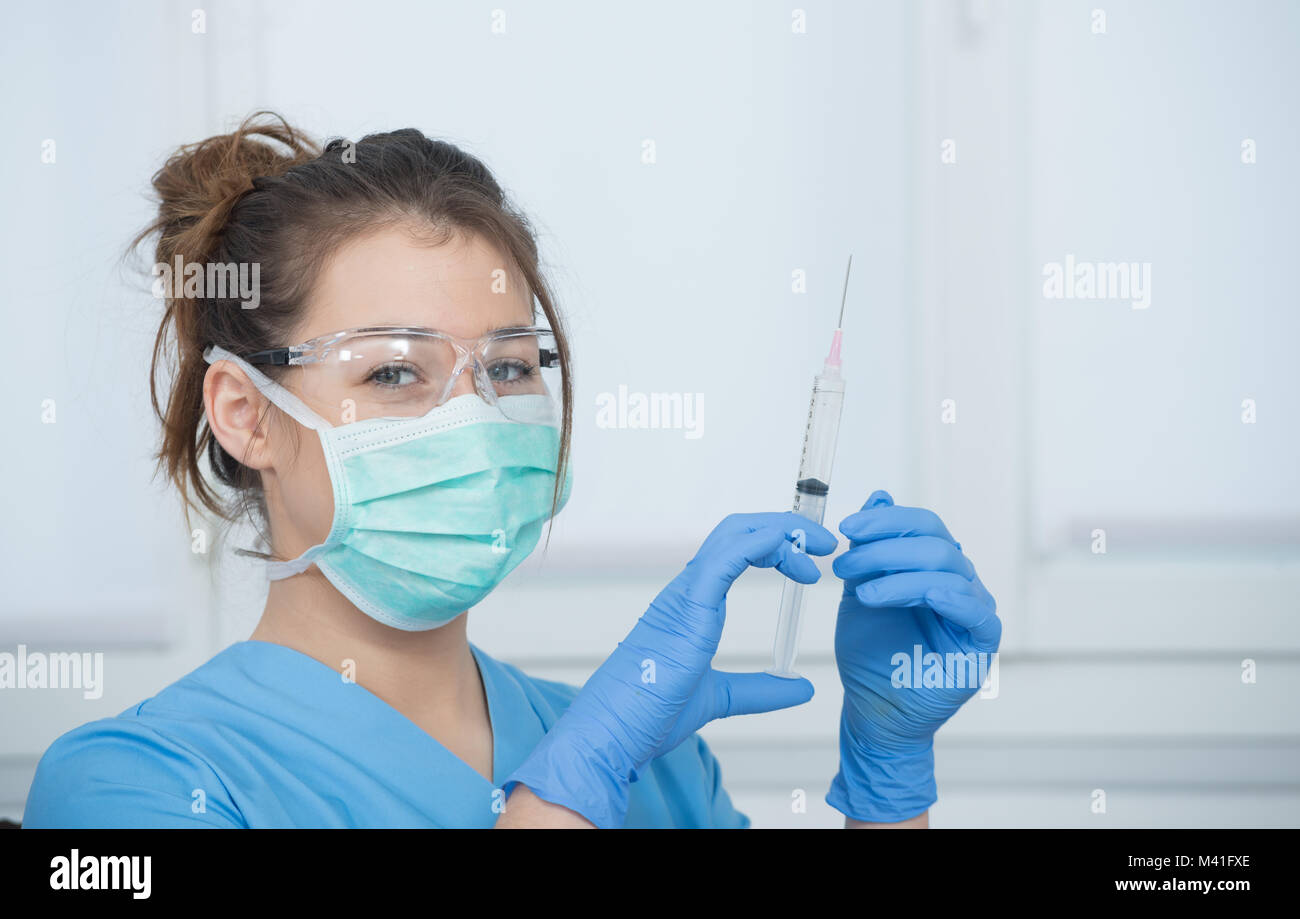young nurse preparing injection with a syringe in hospital Stock Photo ...