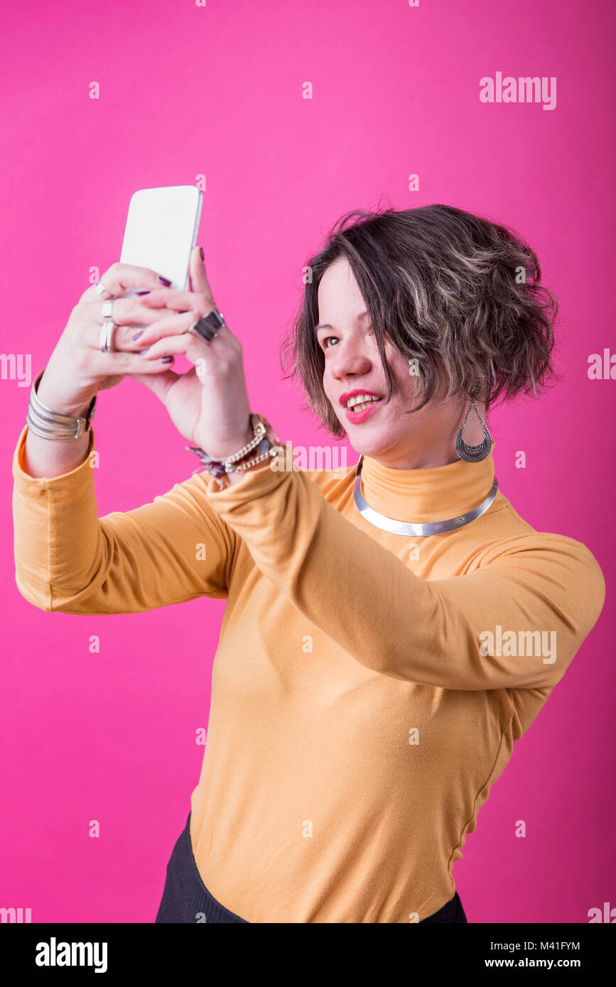 Cute woman taking a snapshot Stock Photo - Alamy