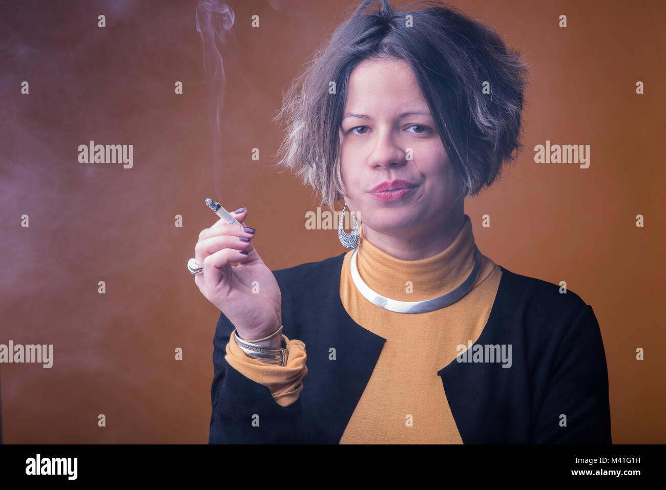Classy stylish woman smoking Stock Photo - Alamy
