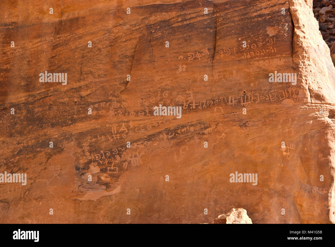 Ancient inscriptions tamudiche on the sandstone rock in the Wadi Rum ...