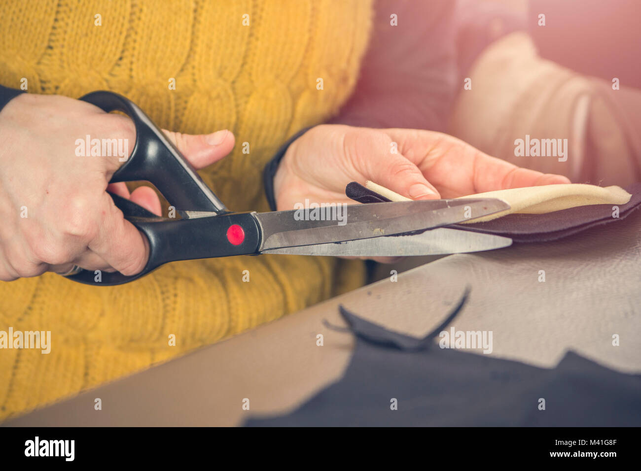 Young tailor cutting clothing material Stock Photo - Alamy