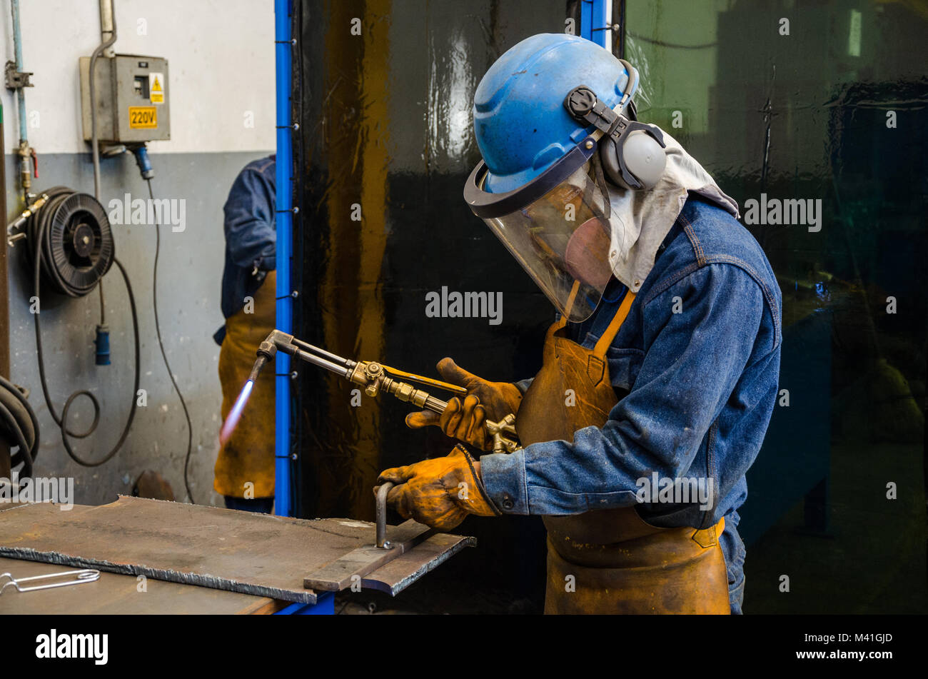 worker cutting iron with his tool Stock Photo - Alamy