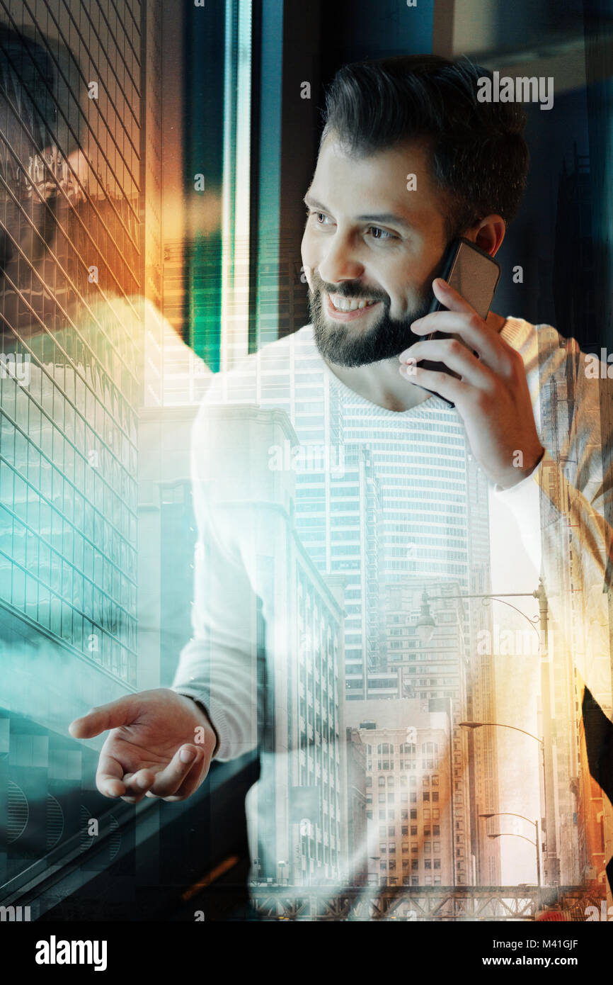 Optimistic person feeling glad while talking on the phone Stock Photo ...