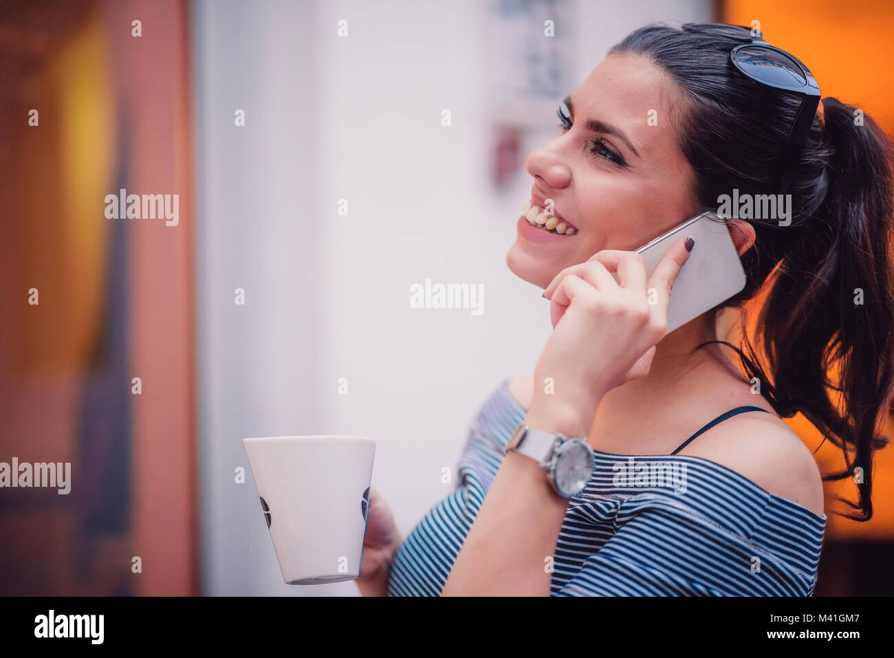 Phone talk in a coffee shop Stock Photo - Alamy