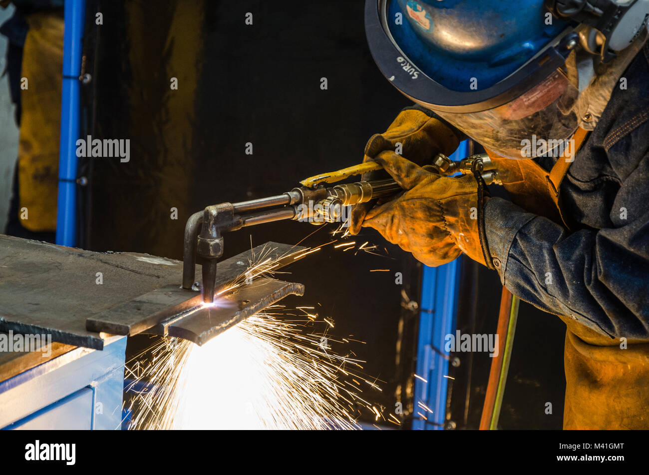worker cutting iron with his tool Stock Photo - Alamy