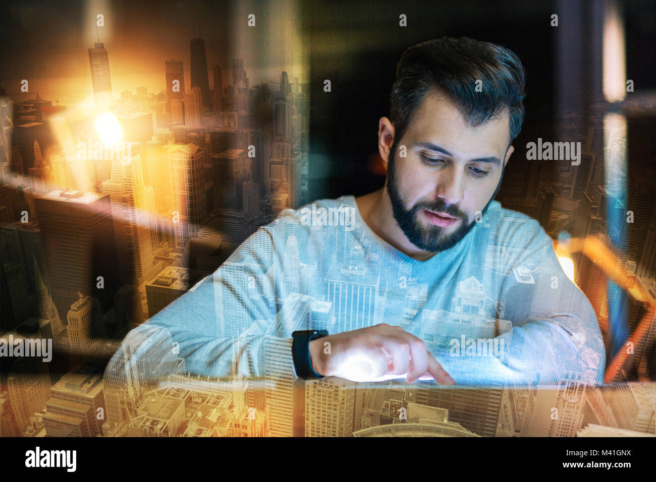 Young man looking at the tablet while checking his schedule Stock Photo ...