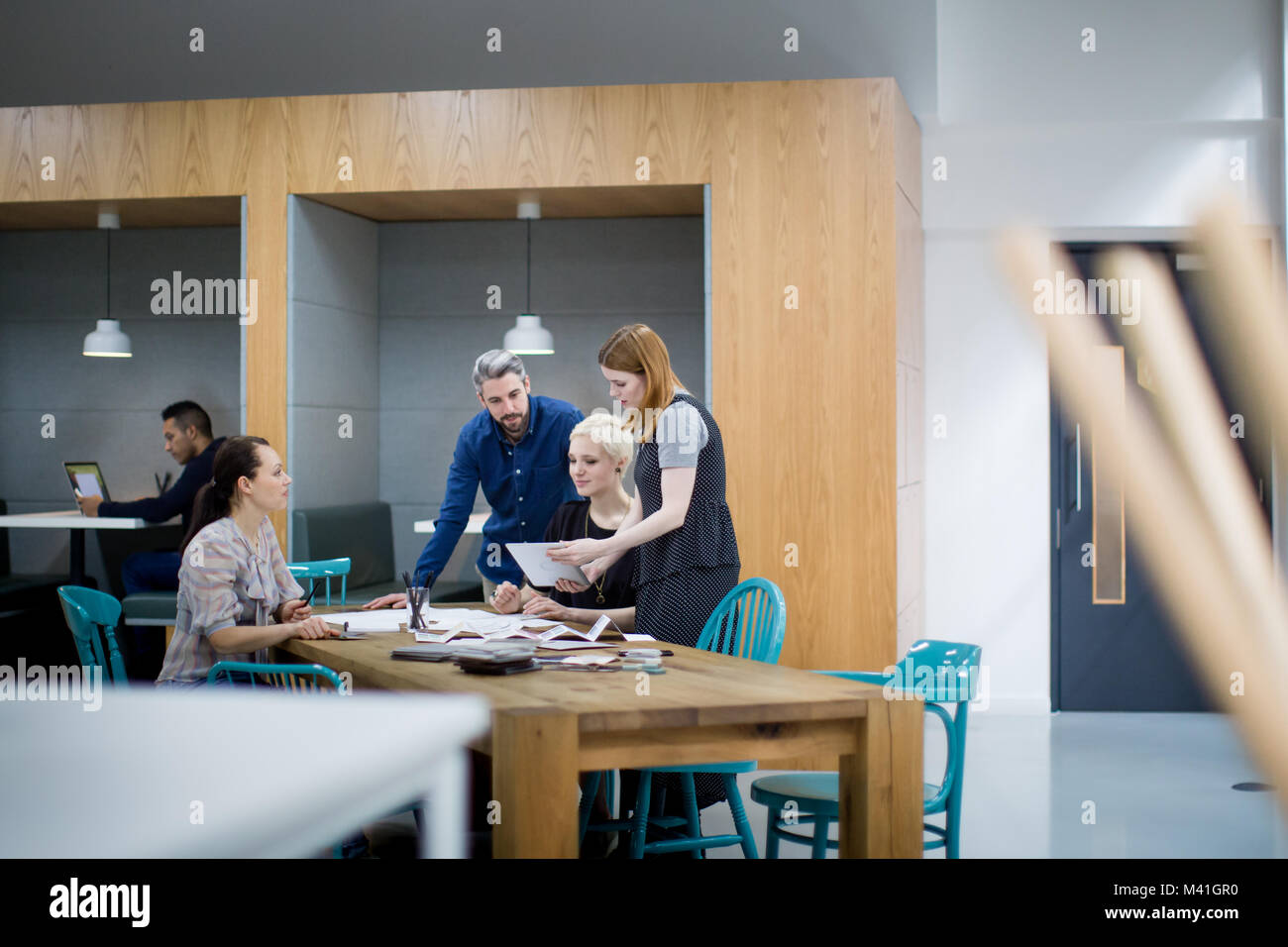 Group of coworkers discussing a project Stock Photo - Alamy
