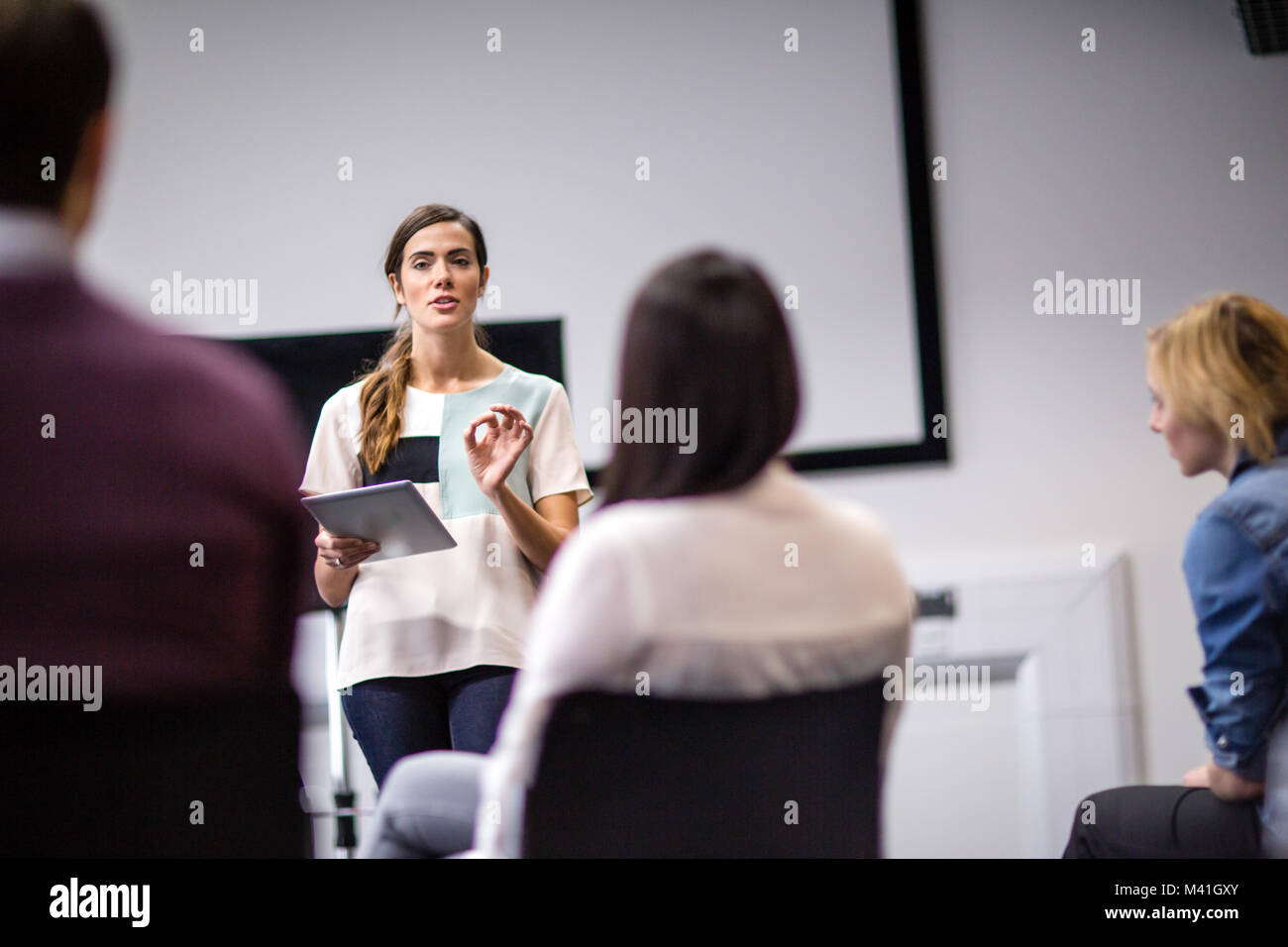 Female executive leading a training conference Stock Photo - Alamy