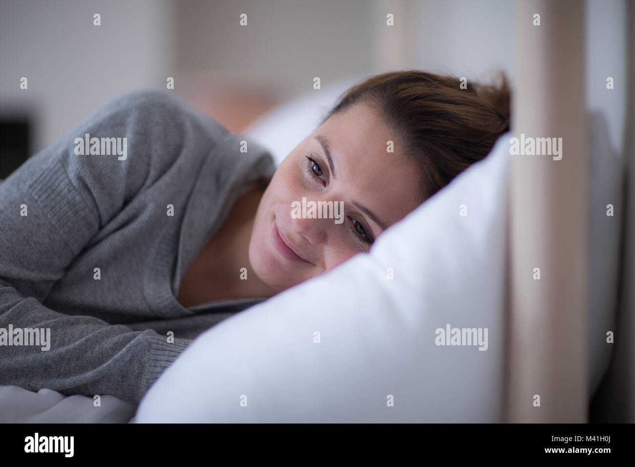 Young adult female waking up in the morning Stock Photo - Alamy