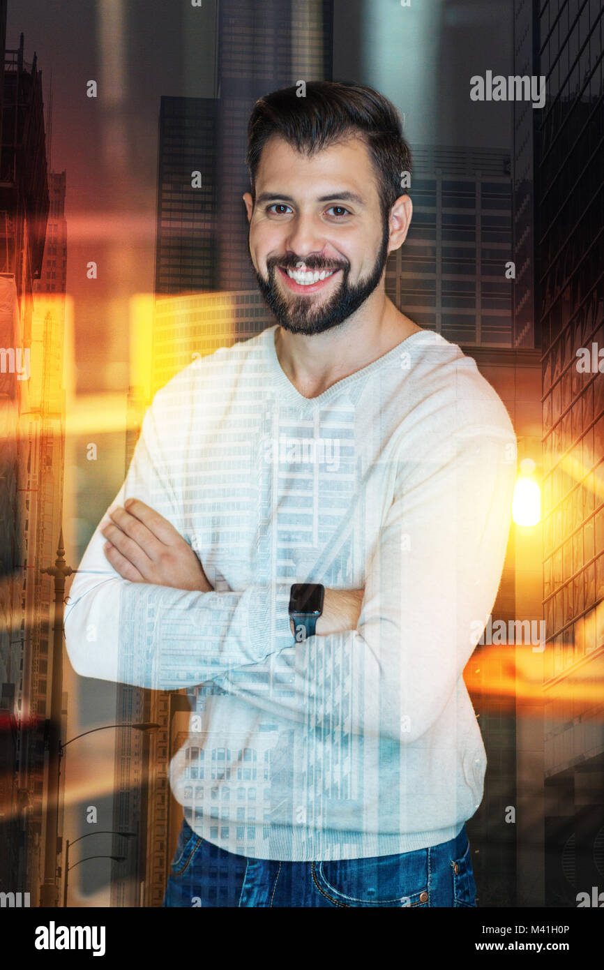 Pleasant man standing with his arms crossed and looking happy Stock ...