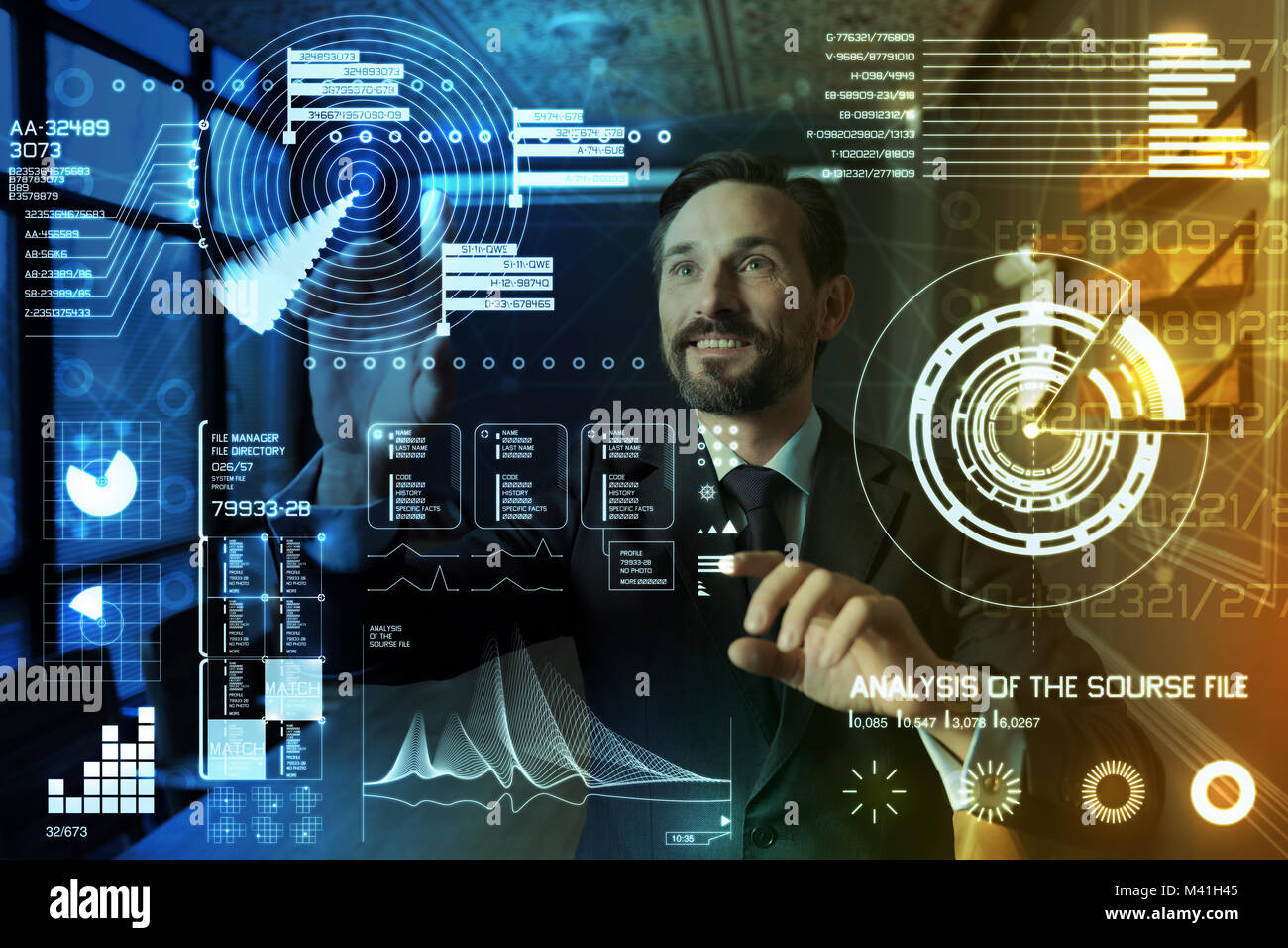 Cheerful programmer smiling happily while looking at the screen Stock ...