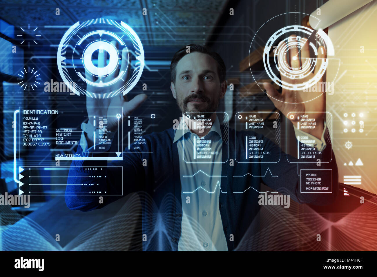 Impressed programmer touching two icons on the transparent screen Stock Photo - Alamy