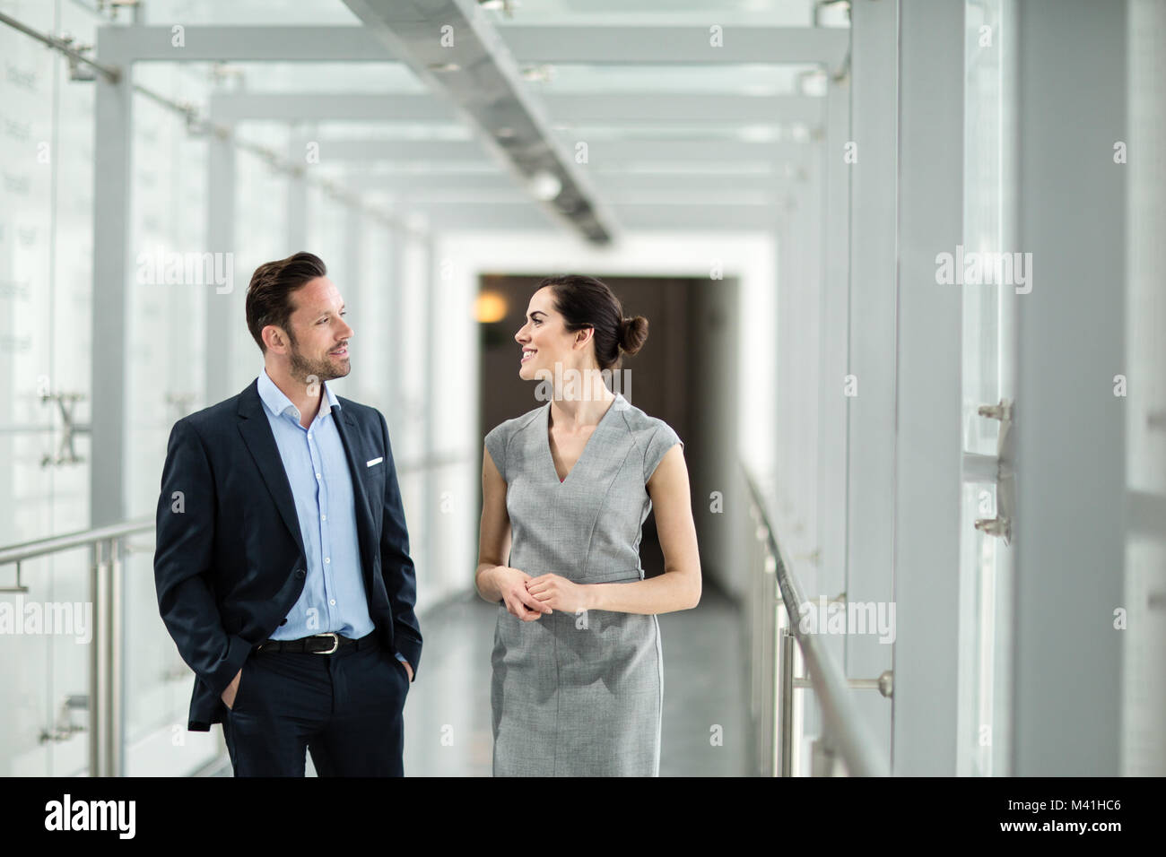 Business colleagues walking through office corridor Stock Photo - Alamy