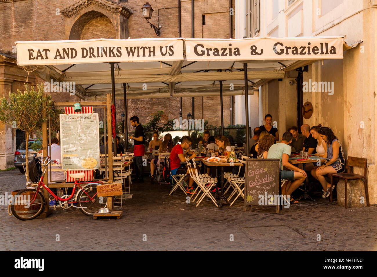 Young people enjoying dining out together at a traditional trattoria ...