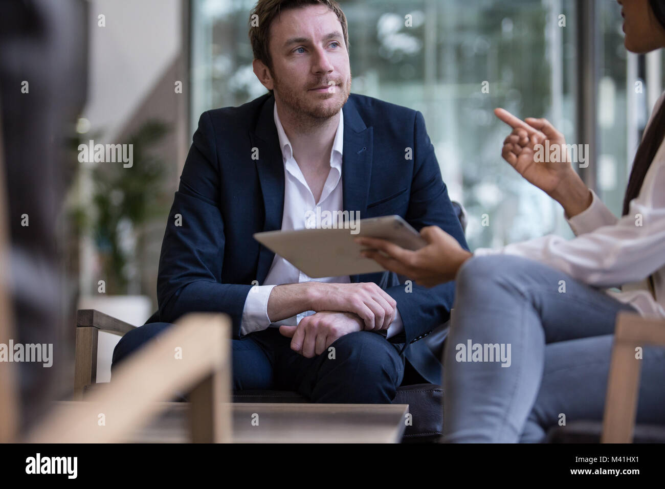 Businessman listening in a meeting Stock Photo - Alamy