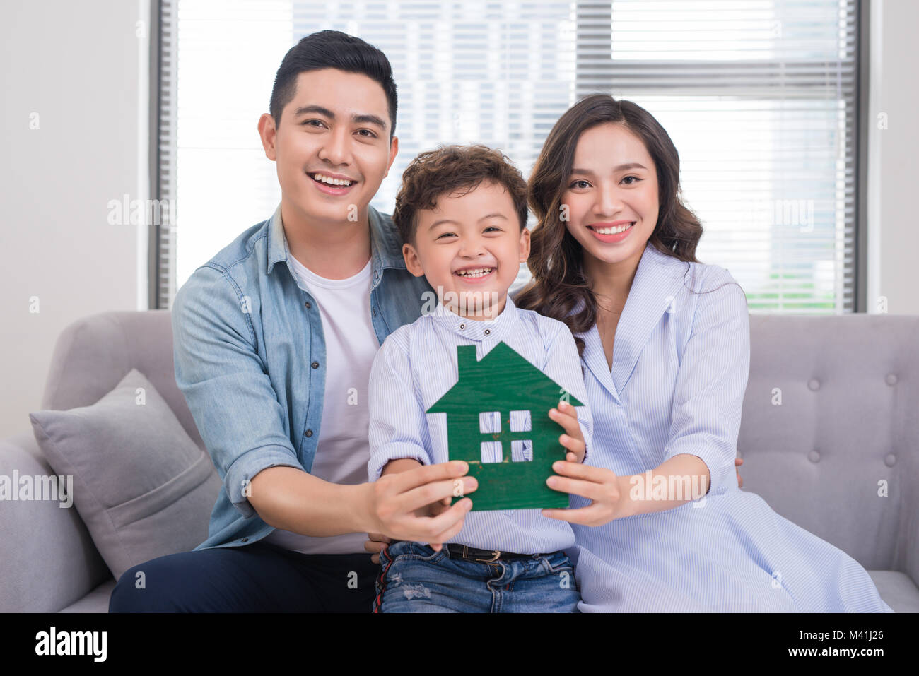 Smiling young parents and their child are very happy Stock Photo - Alamy