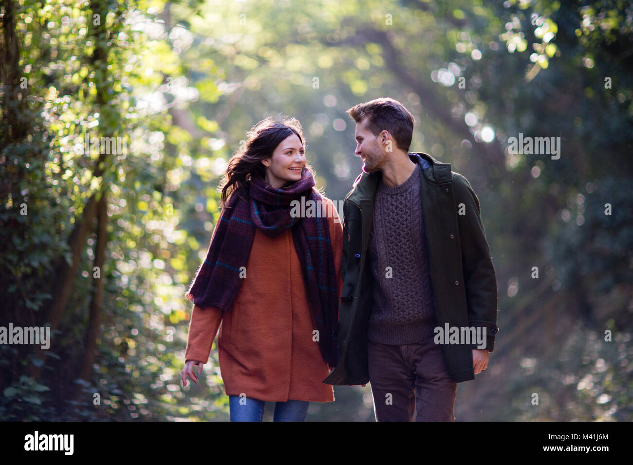 Couple having a walk in forest in autumn Stock Photo - Alamy