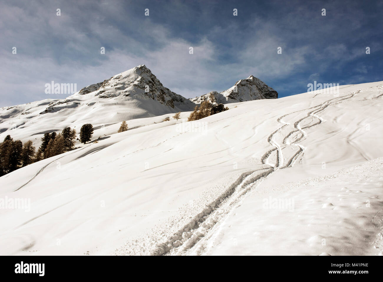 A view of a ski piste and snowy mountains in the alps switzerland in ...