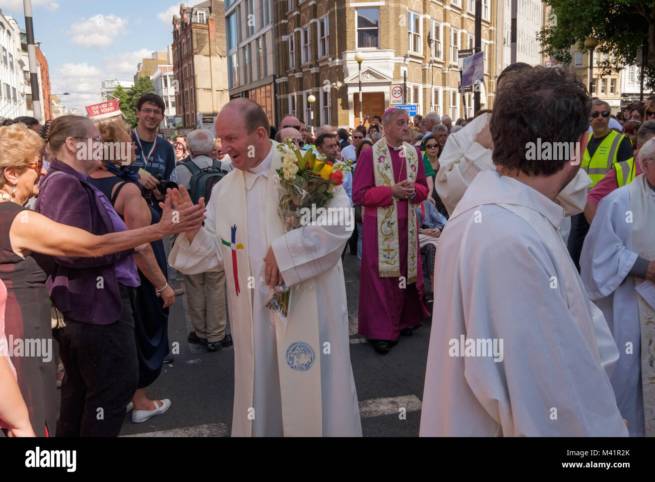 The clergy are greeted by parishoners as the procession at the Festival ...