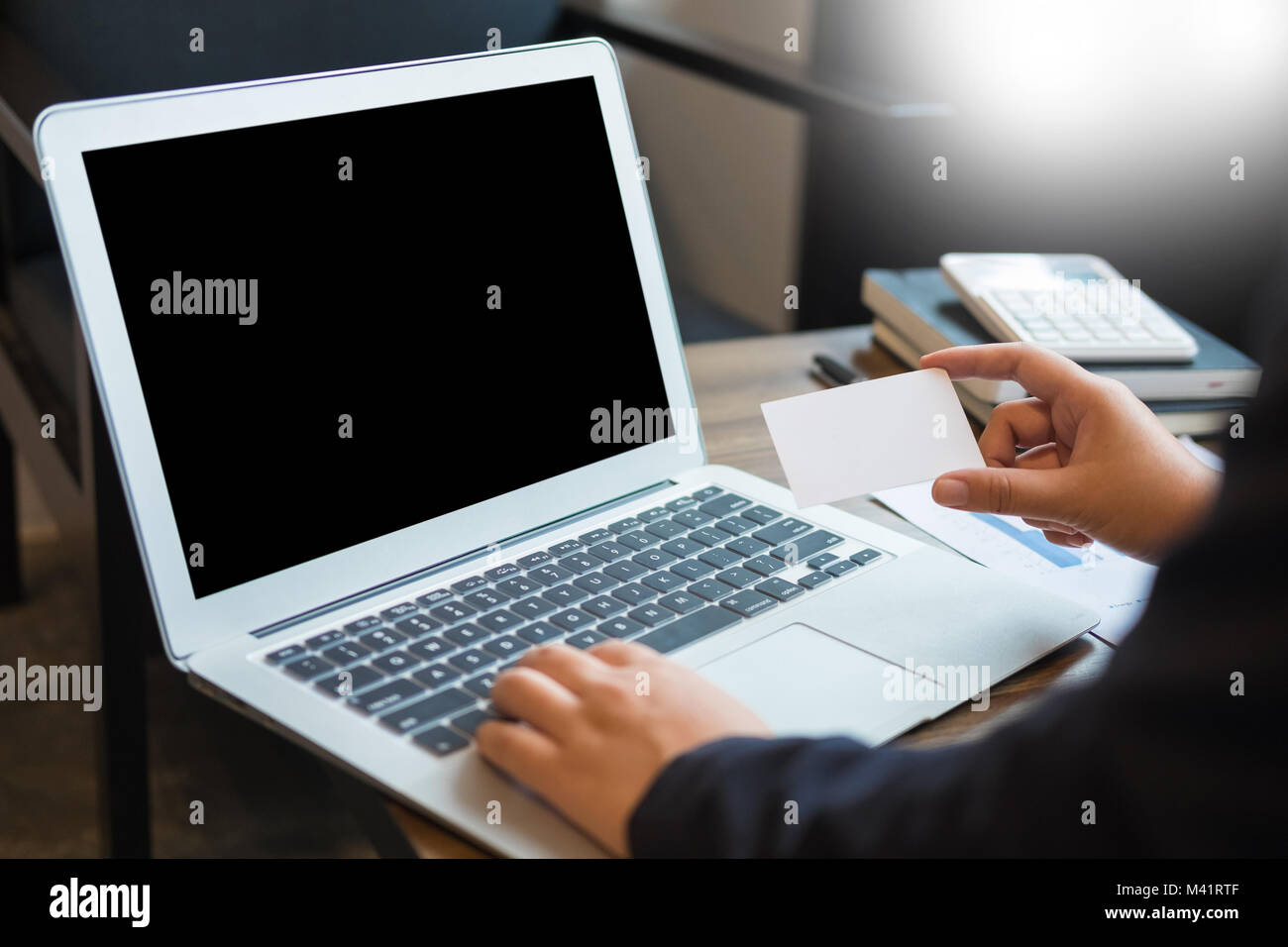 Man holding credit card in hand and entering security code using smart ...