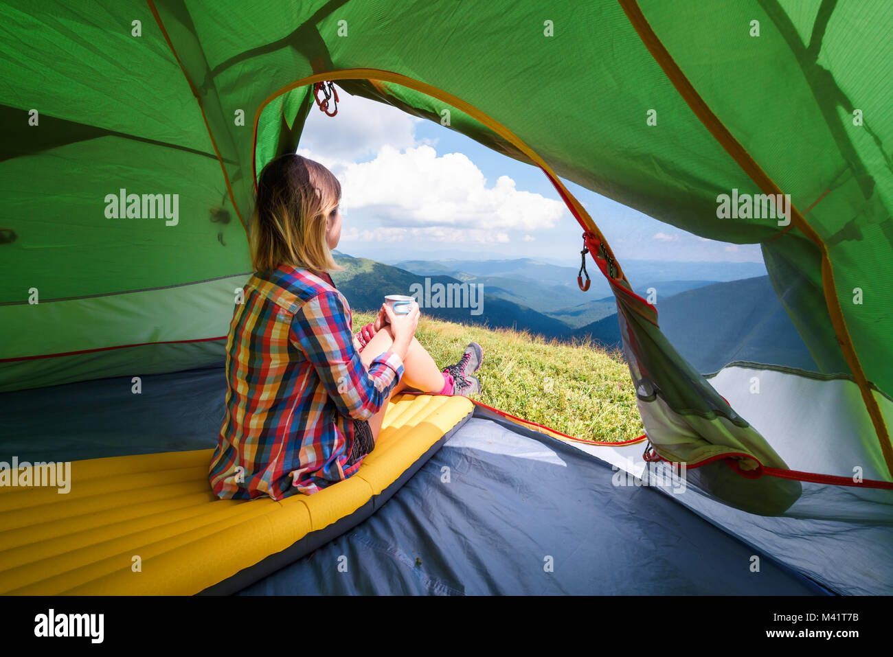 Girl sitting in they tent Stock Photo - Alamy