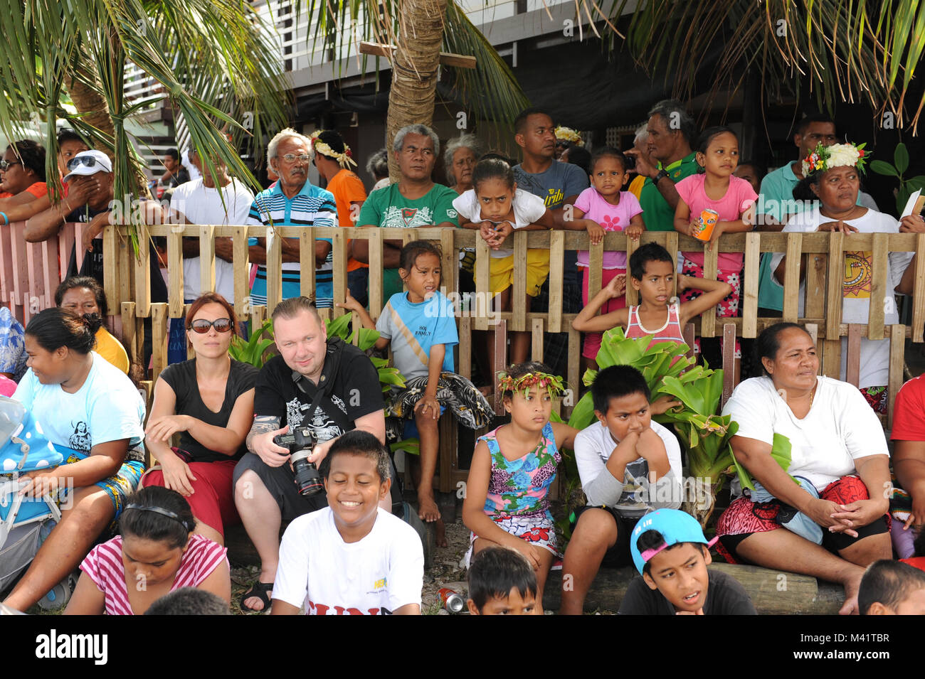 Tuvaluans and tourists watch the parade through Funafuti during annual ...