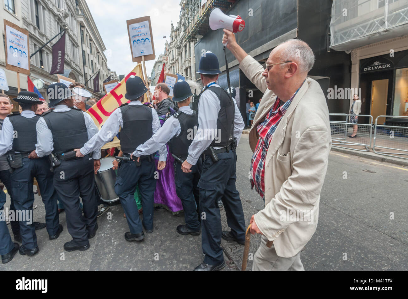 Ian Bone of Class War holds up a megaphone on siren setting as police ...