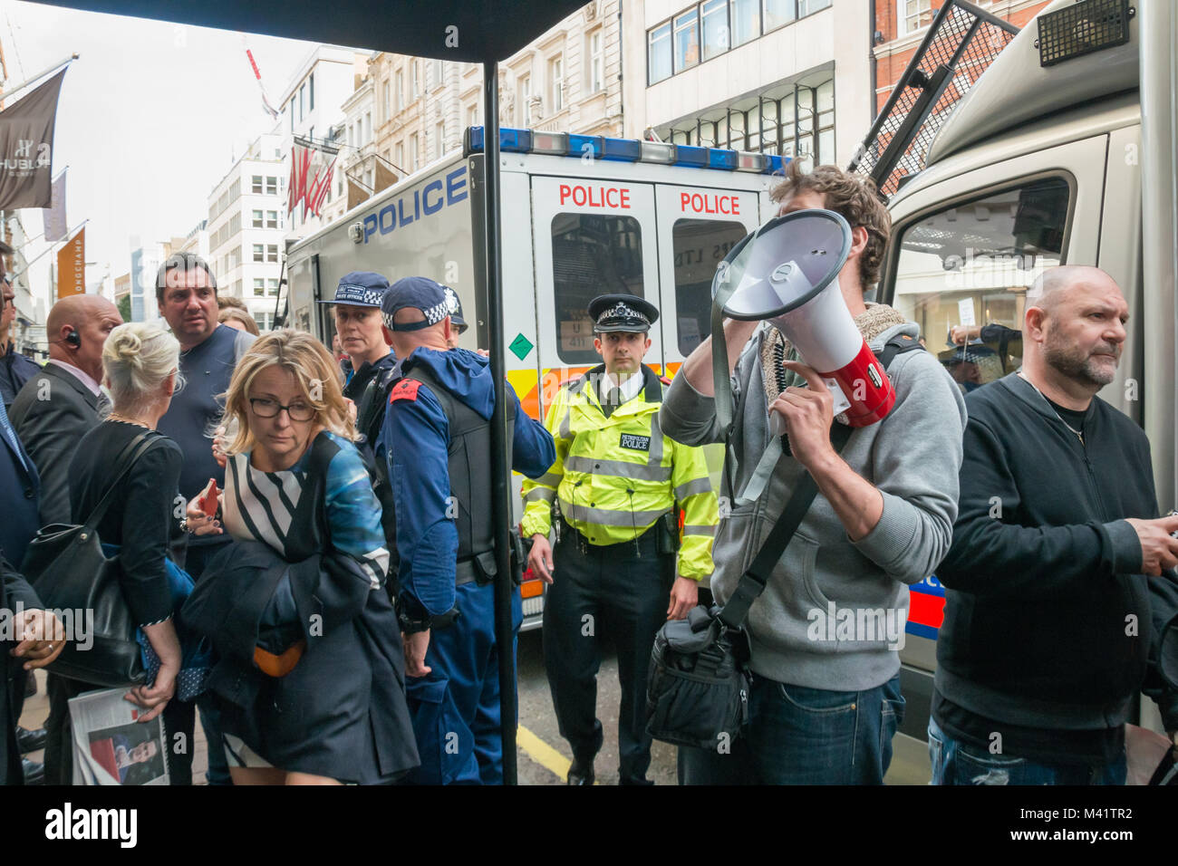 Police and security obstruct the pavement outside Sotheby's in Old Bond ...