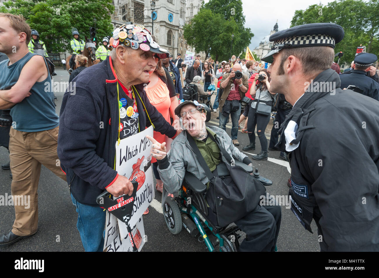 Police argue with protesters, one in a wheelchair as they try to clear ...