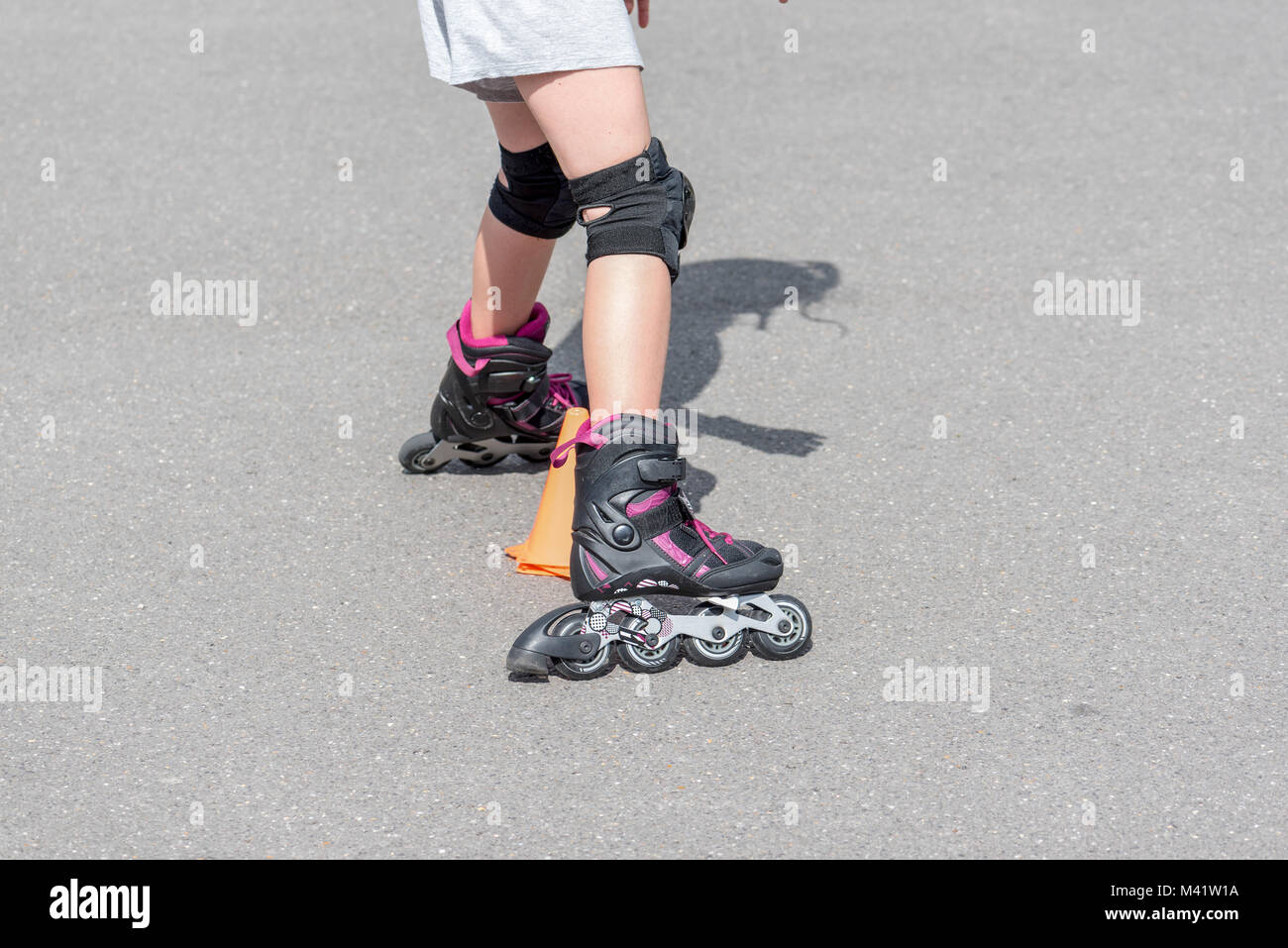 Little girl doing rollerblade in the street Stock Photo - Alamy