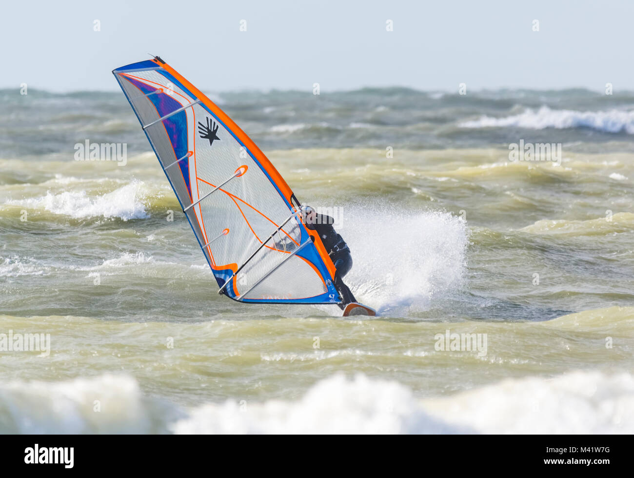 Man windsurfing (AKA sailboarding) on a rough sea on a windy day in ...