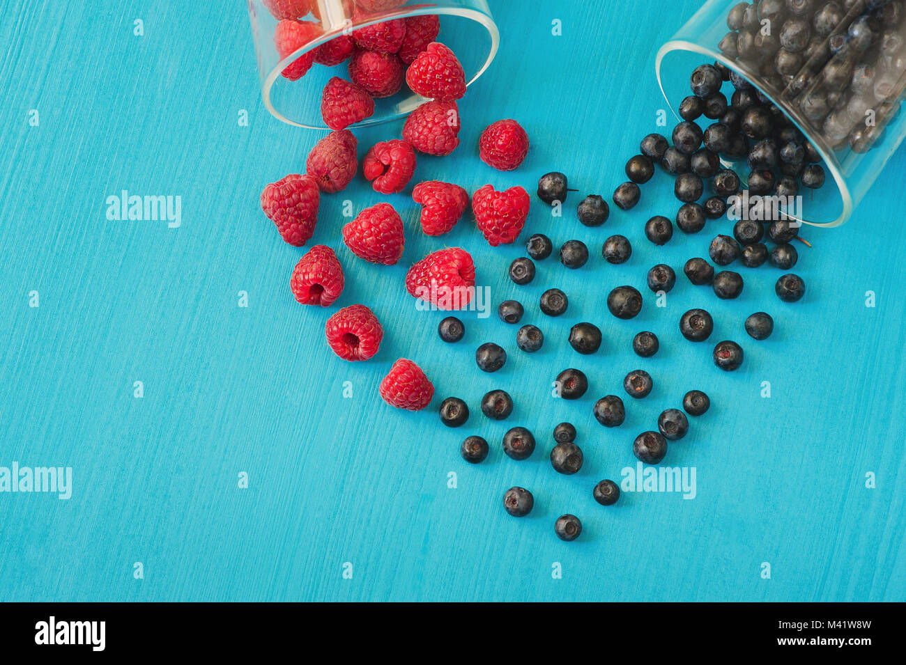 Heart shape of fresh raspberries and blueberries Stock Photo - Alamy