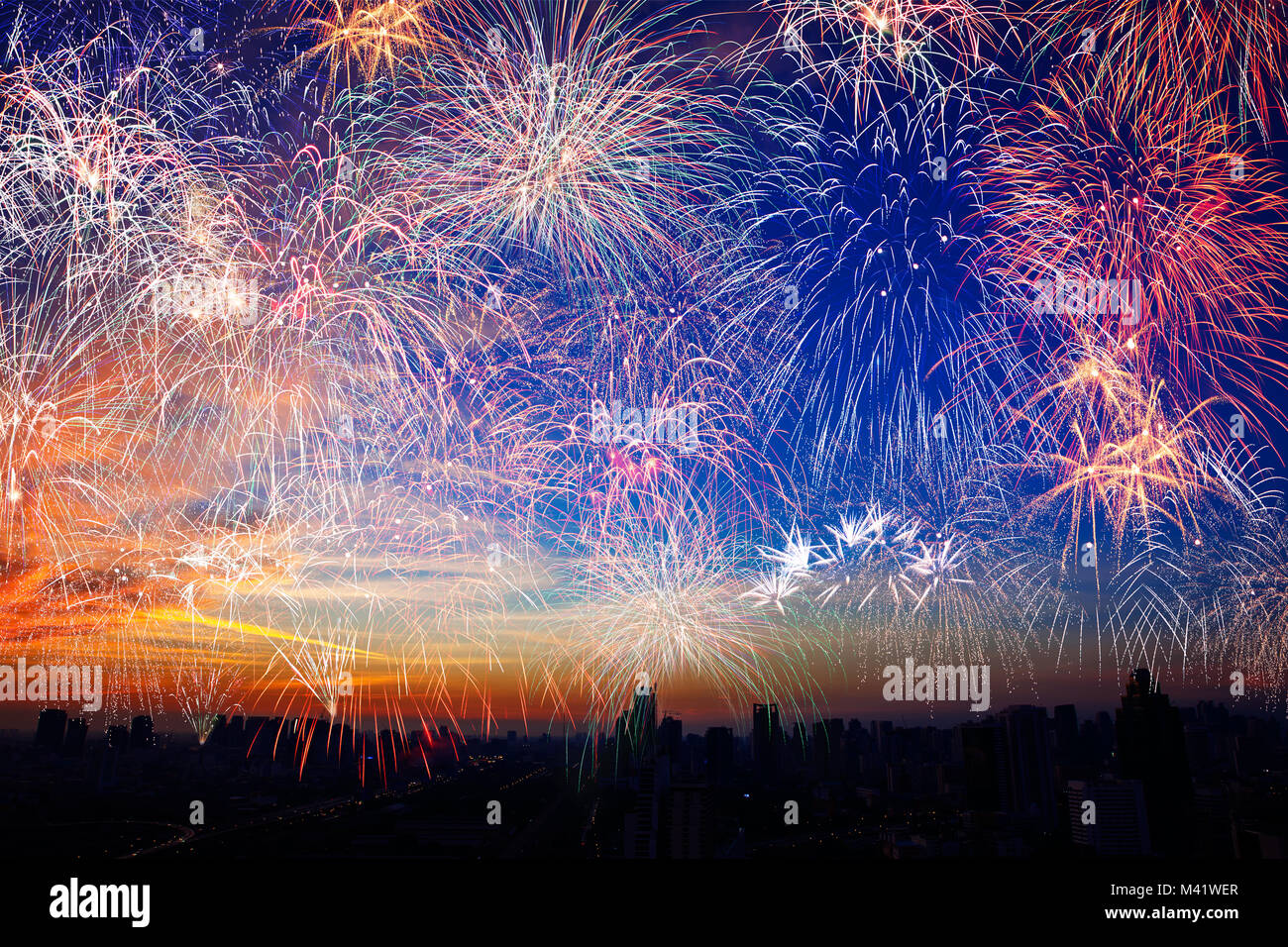 Fireworks in the sky at sunset city. Holiday festival background Stock ...