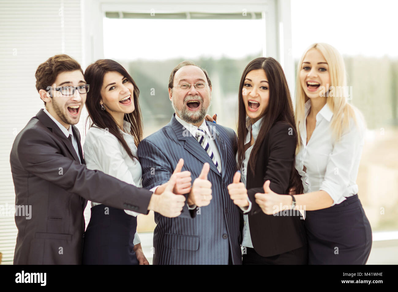 Portrait triumphant business team hi-res stock photography and images ...