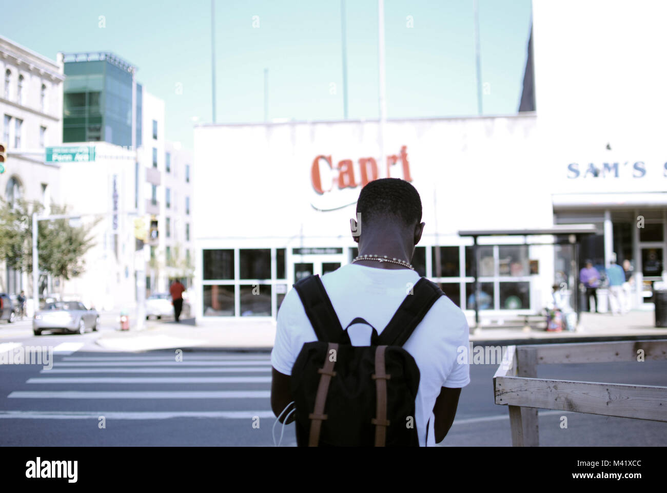 Man standing outside a store Stock Photo - Alamy
