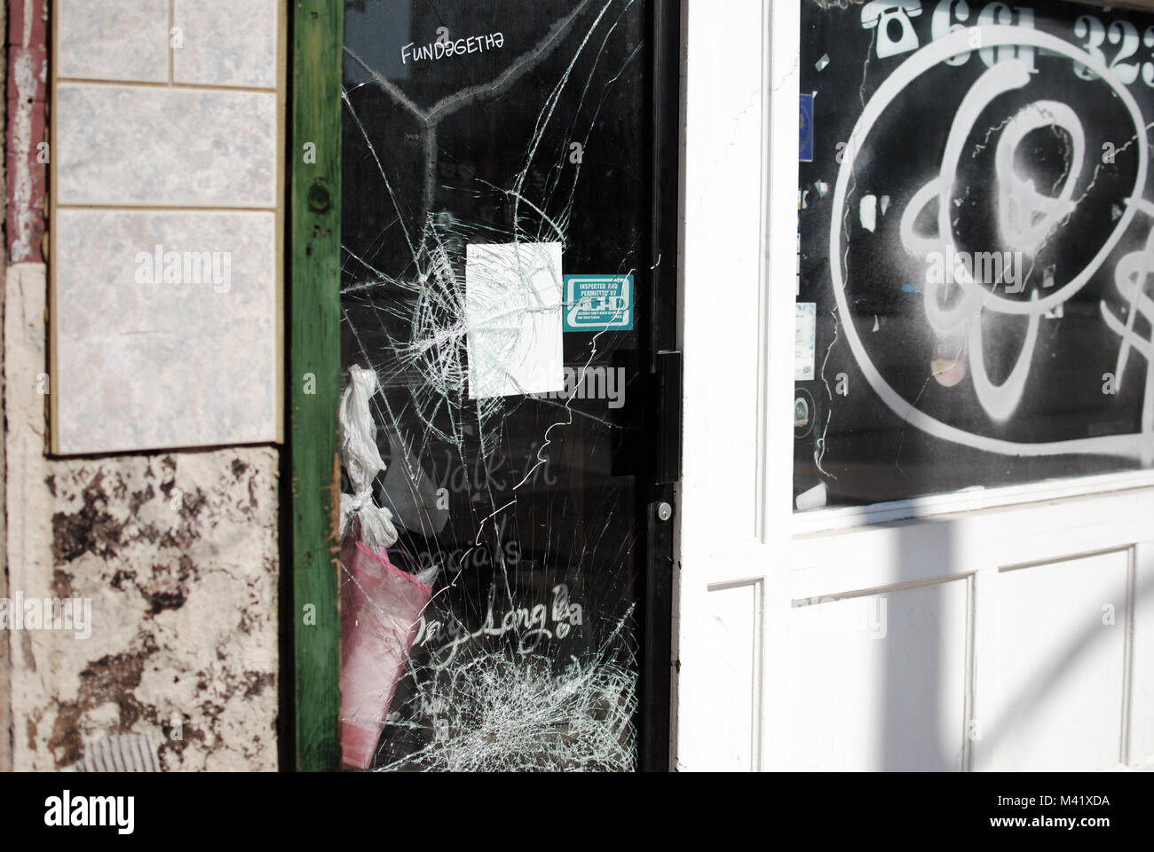 Broken door of an abandoned store Stock Photo - Alamy