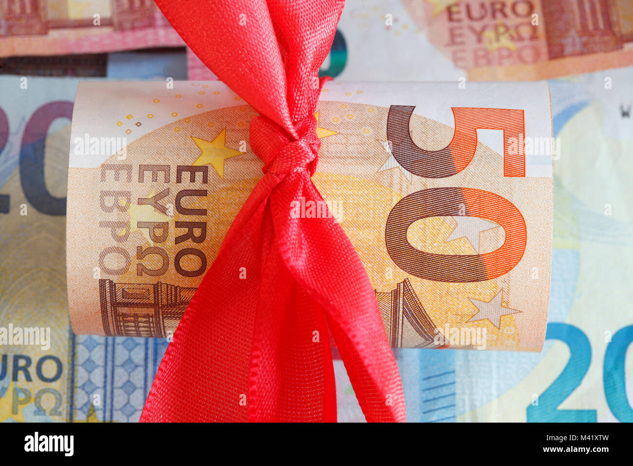 monetary role with Euro Bank Notes and red loop as a Present Stock ...