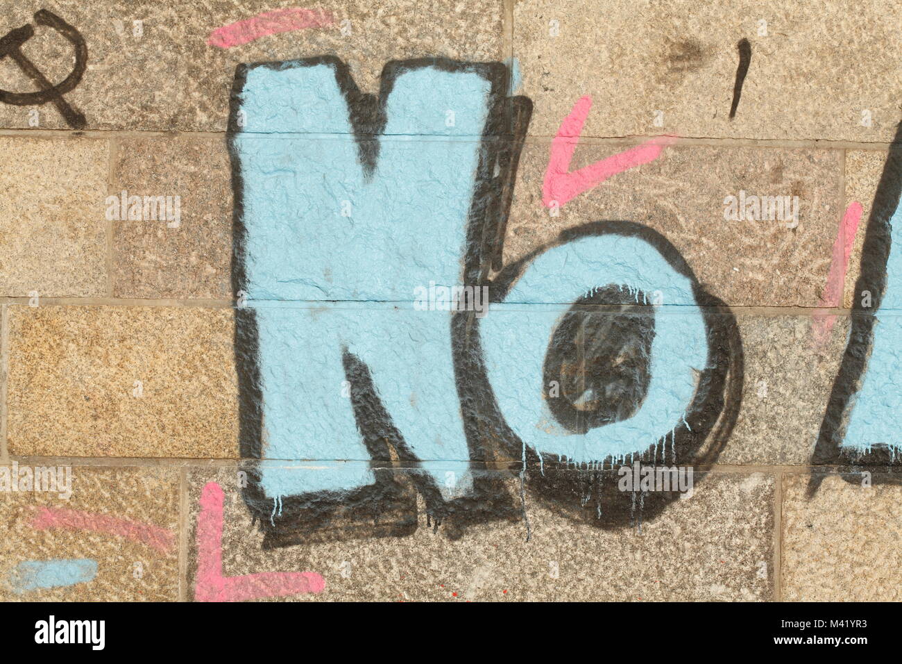 brown painted wall with blue Letters No Stock Photo - Alamy