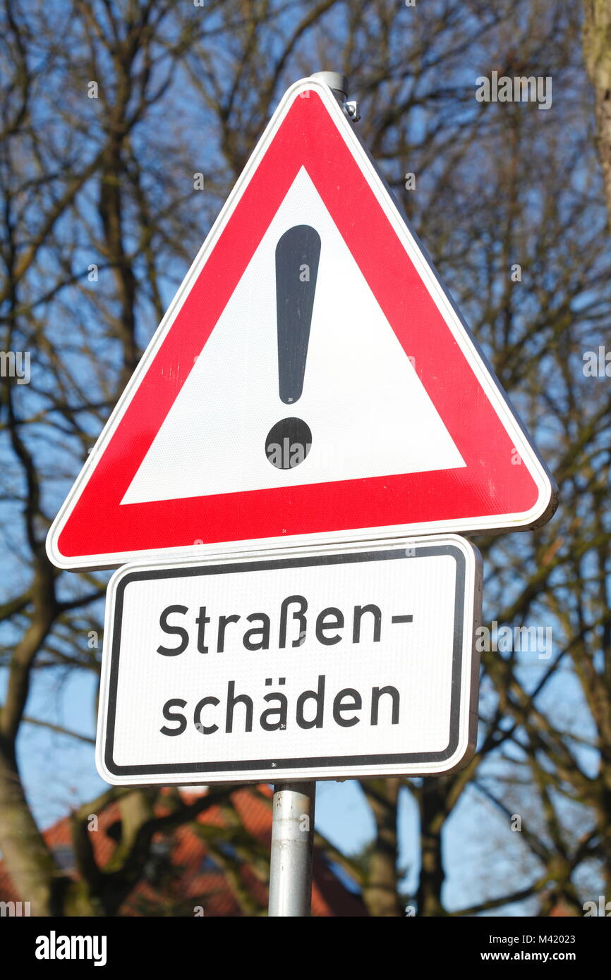 Road Sign danger place, street damages with blue sky Stock Photo - Alamy