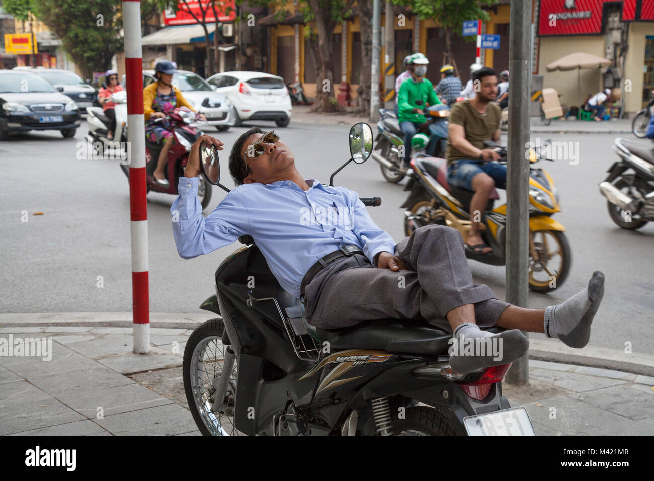 Man sleeping on motorbike hi-res stock photography and images - Alamy