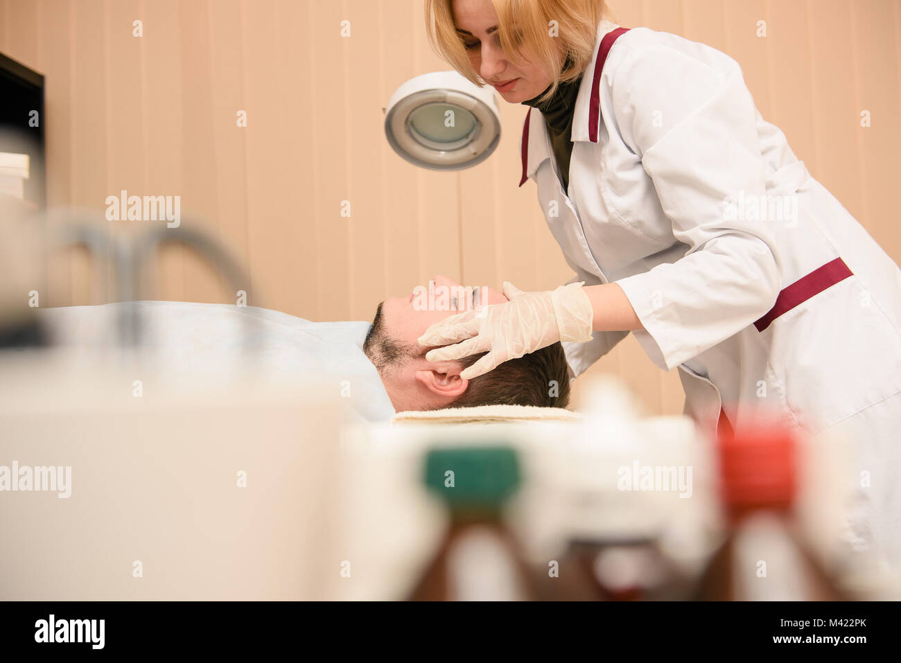 Female doctor touch face of male patient in latex gloves Stock Photo ...