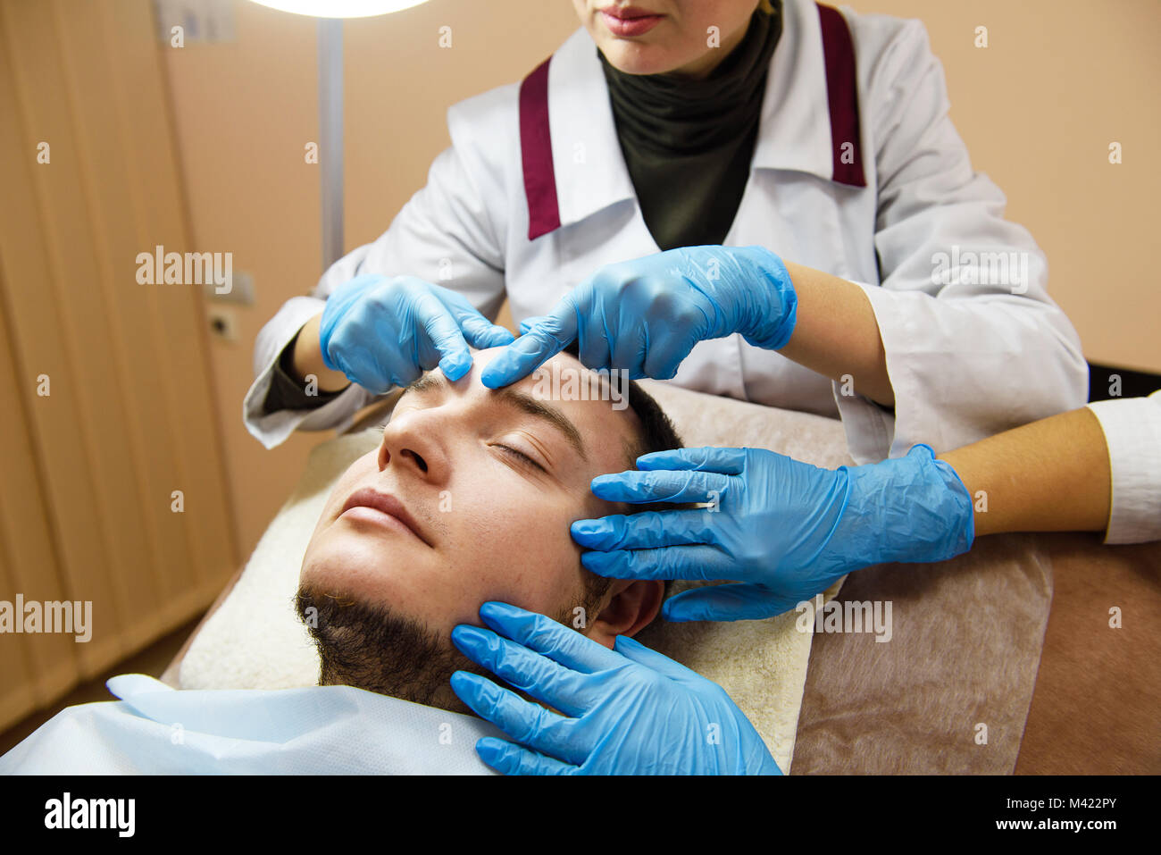 Two doctors and patient Stock Photo - Alamy