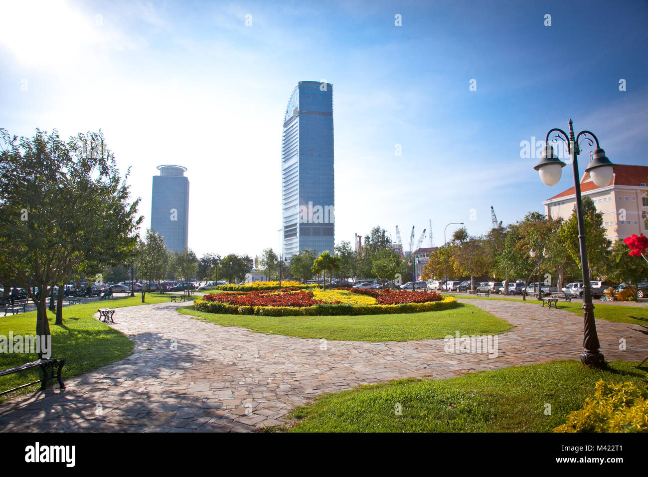 Park in centre of Phnom Penh, Cambodia. New modern glass building shows ...