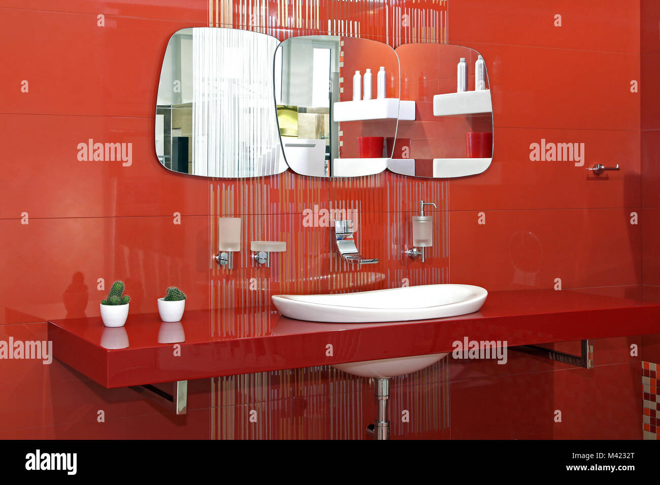 Modern bathroom with red ceramic walls and contemporary fixtures Stock ...