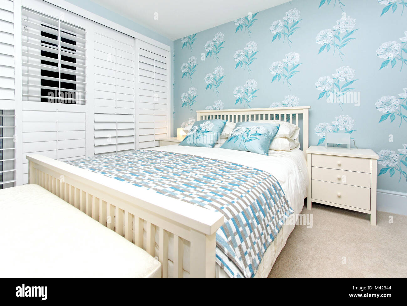 Modern bedroom interior with blue floral pattern wall Stock Photo - Alamy