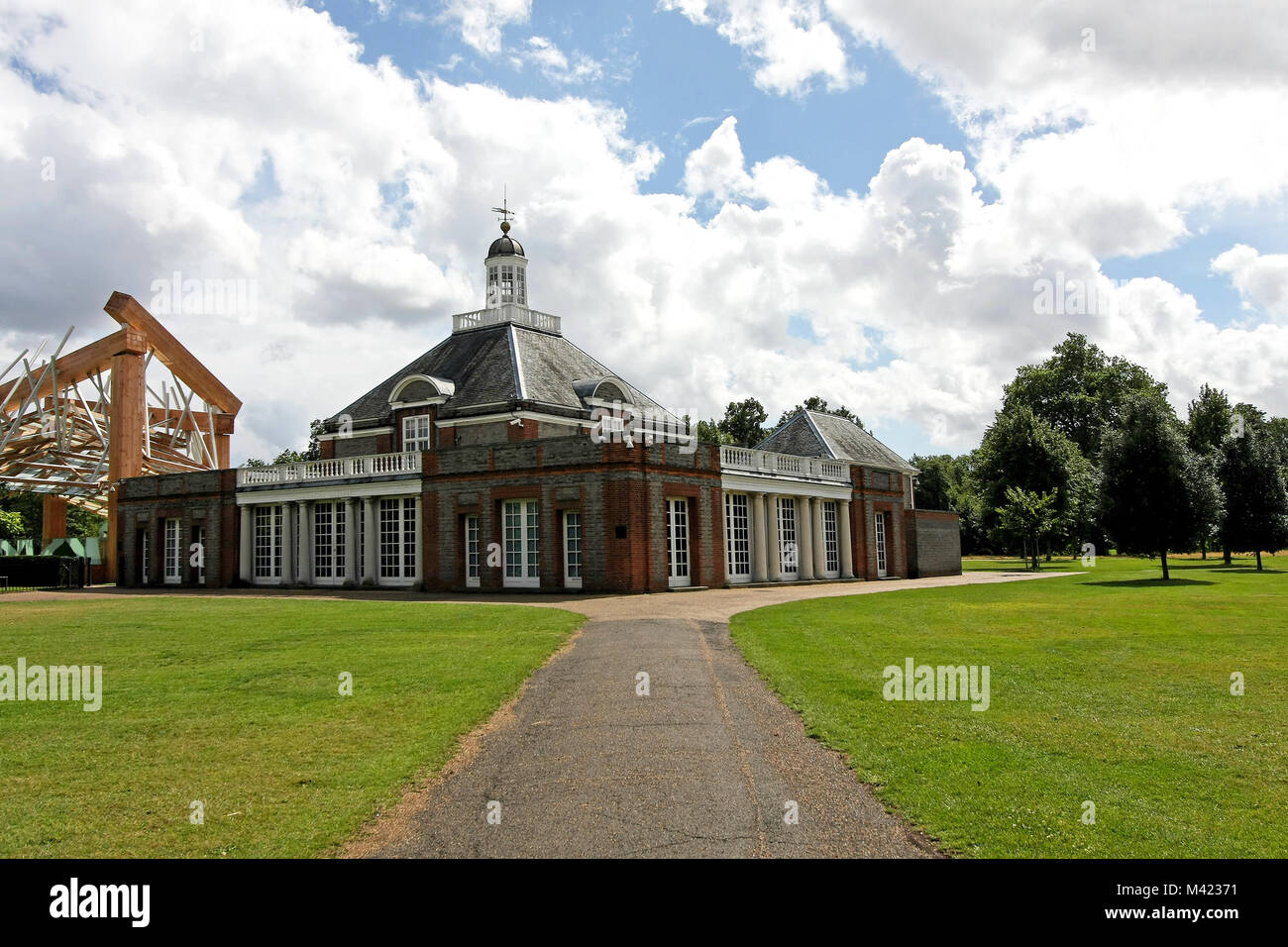 Old garden house in park with lawn and walking path Stock Photo - Alamy