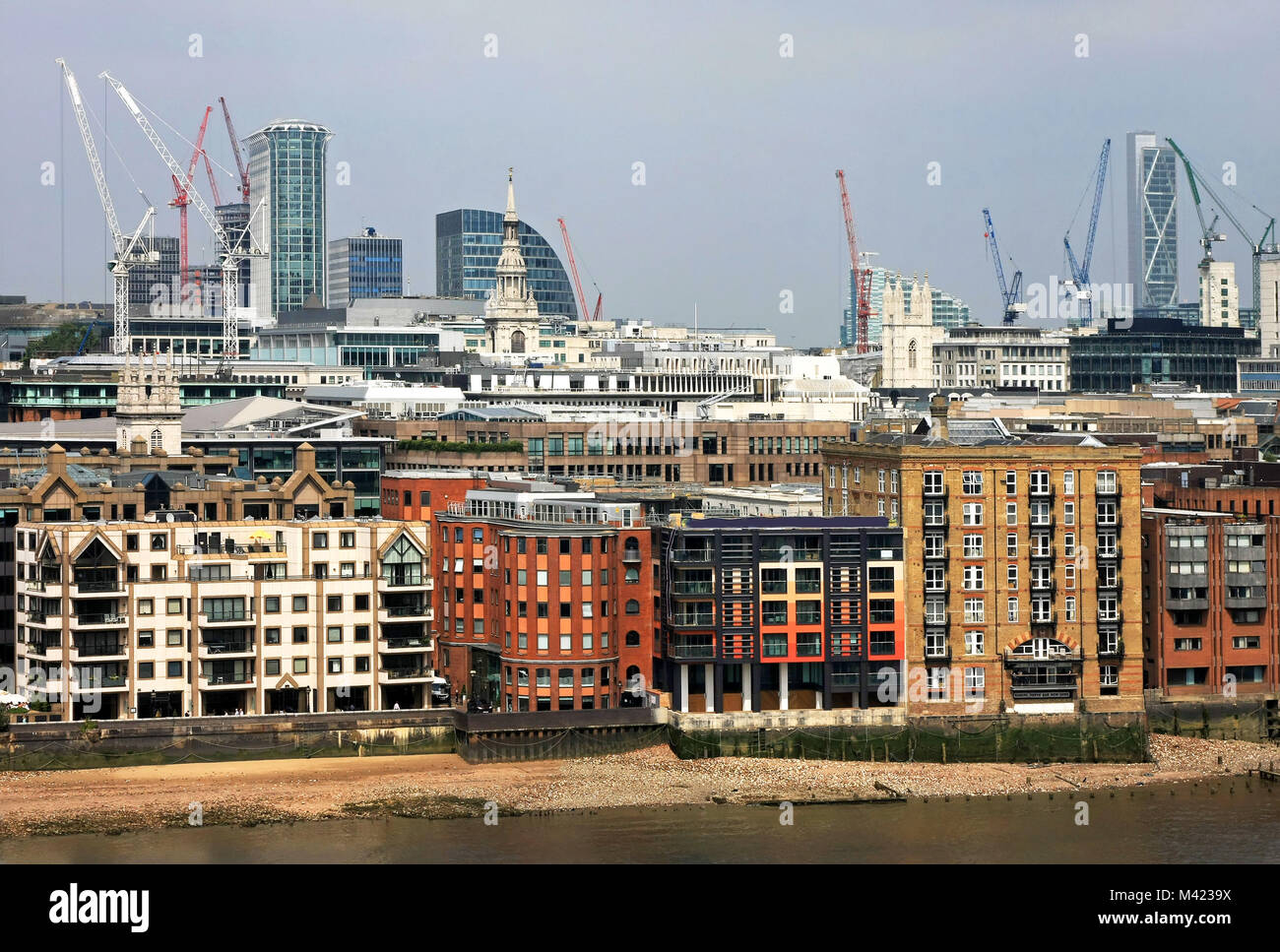 London cityscape from Thames river with building construction sites in ...
