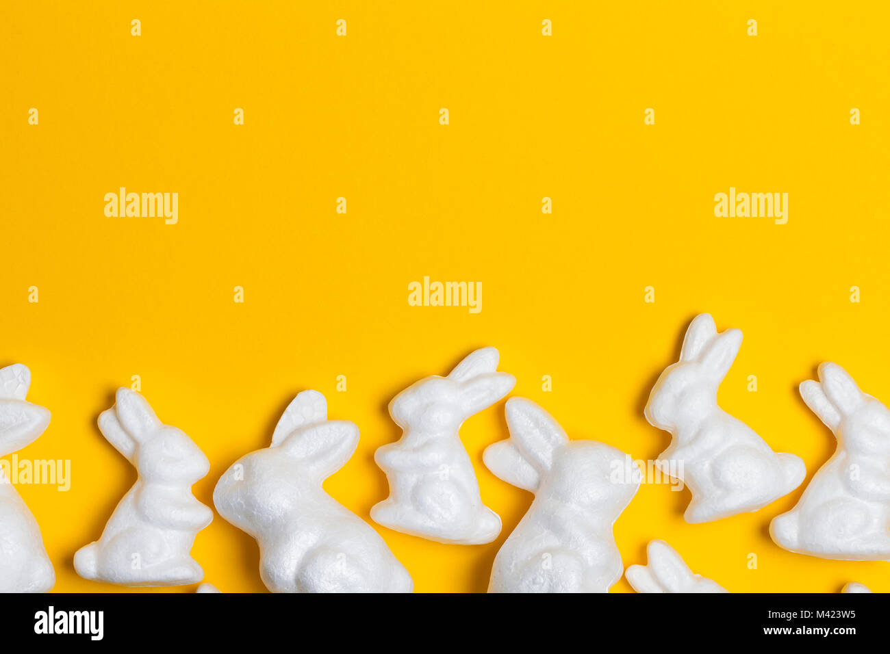 Easter bunny rabbits on a bright yellow background Stock Photo - Alamy