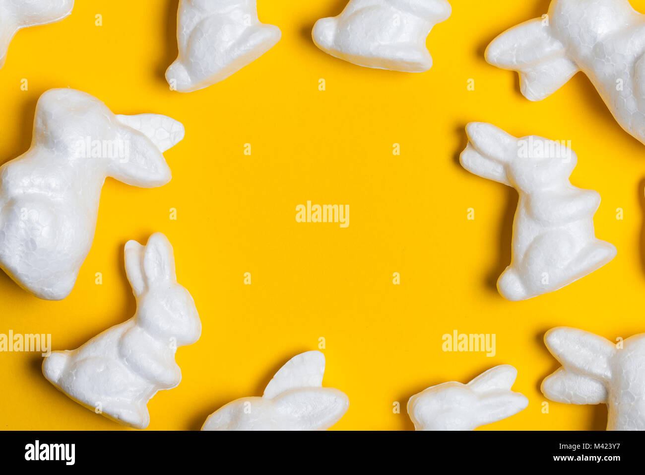Easter bunny rabbits on a bright yellow background Stock Photo - Alamy